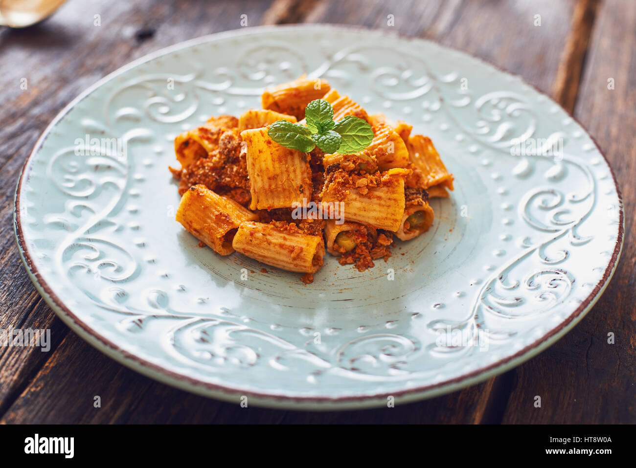 Baked pasta with ragu' sauce on vintage plate Stock Photo - Alamy