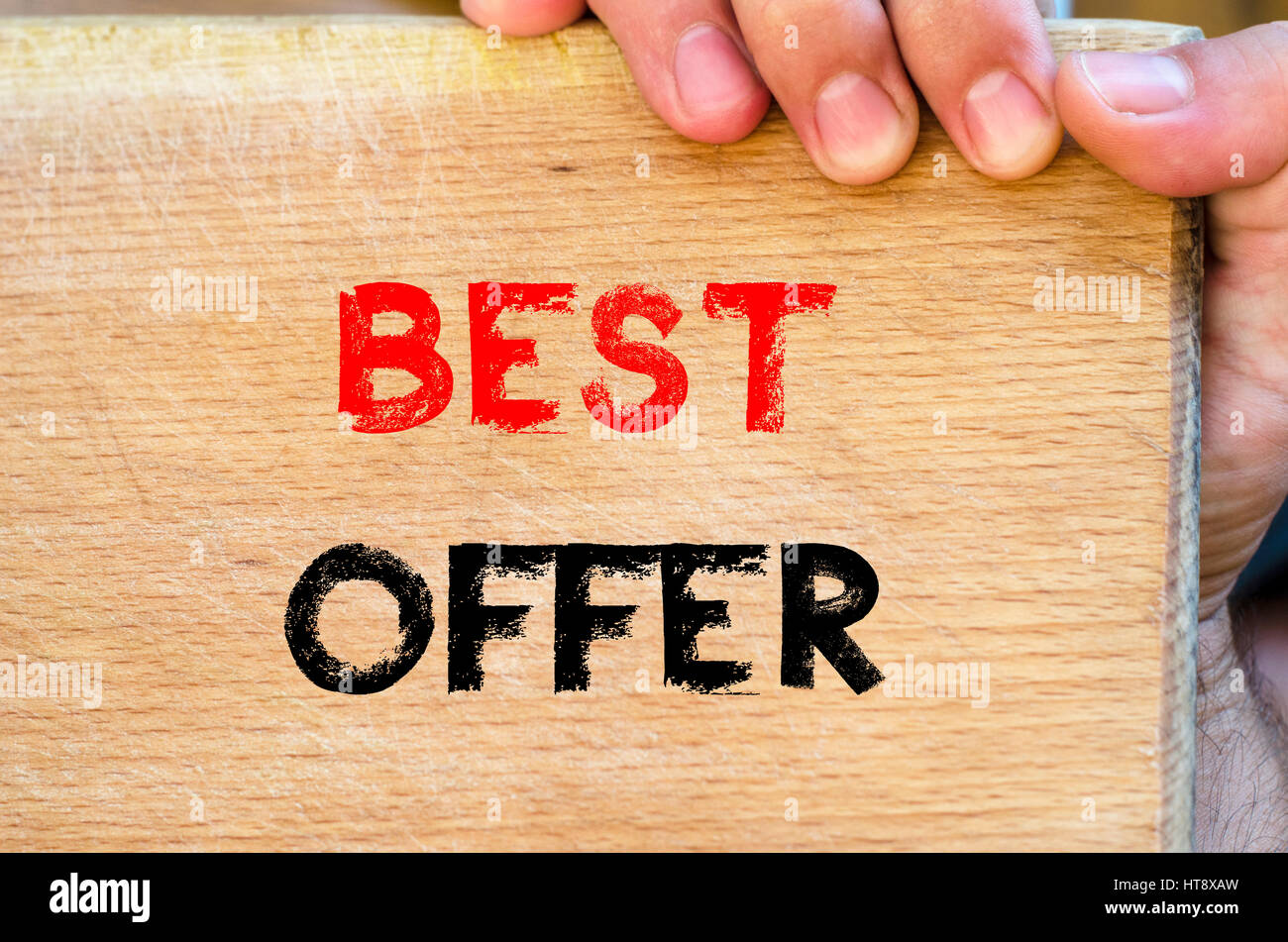 Human hand over wooden background and best offer text concept Stock ...