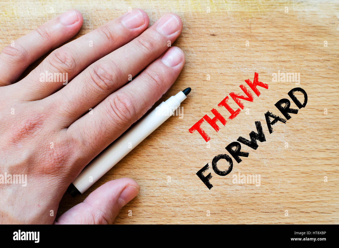 Human hand over wooden background and think forward text concept Stock ...