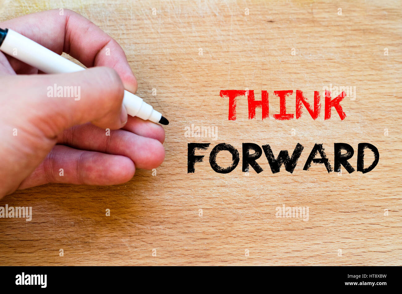 Human hand over wooden background and think forward text concept Stock ...