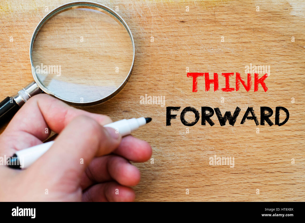 Human hand over wooden background and think forward text concept Stock ...