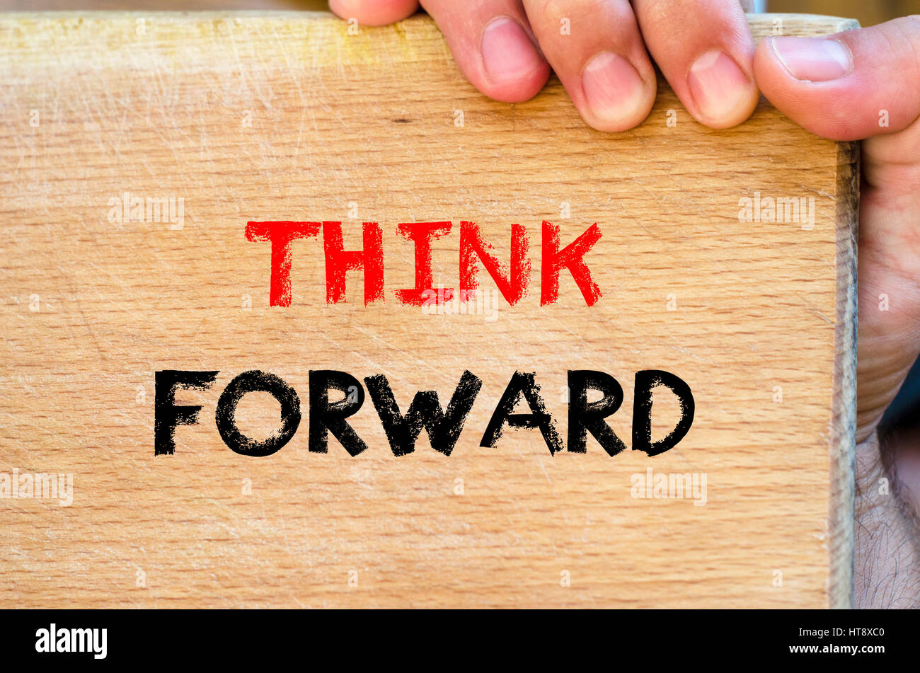 Human hand over wooden background and think forward text concept Stock ...