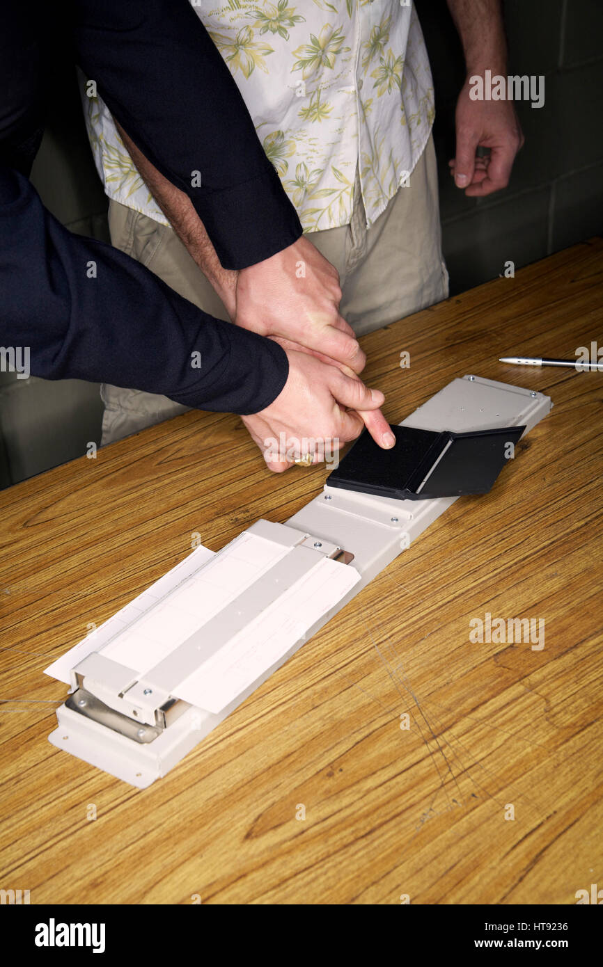 Police officer is taking fingerprints hi-res stock photography and ...
