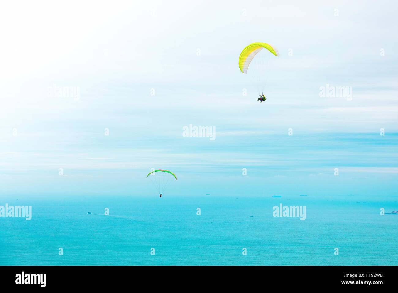 Paragliding above the ocean in Hong Kong East Stock Photo - Alamy