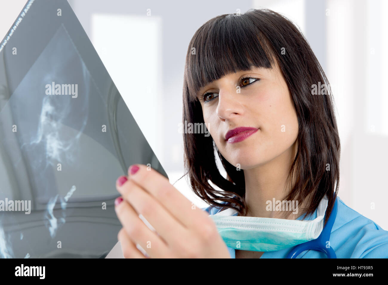 a young female doctor with stethoscope looking at patients x-ray Stock ...