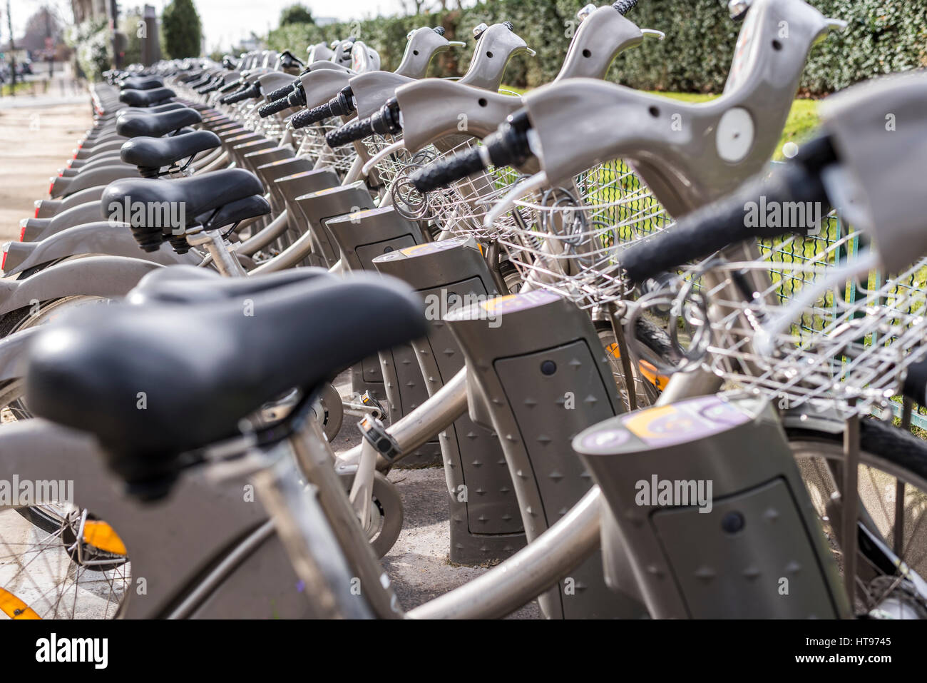 Looking down a row of Velib rental bicycles in Paris France Stock Photo ...