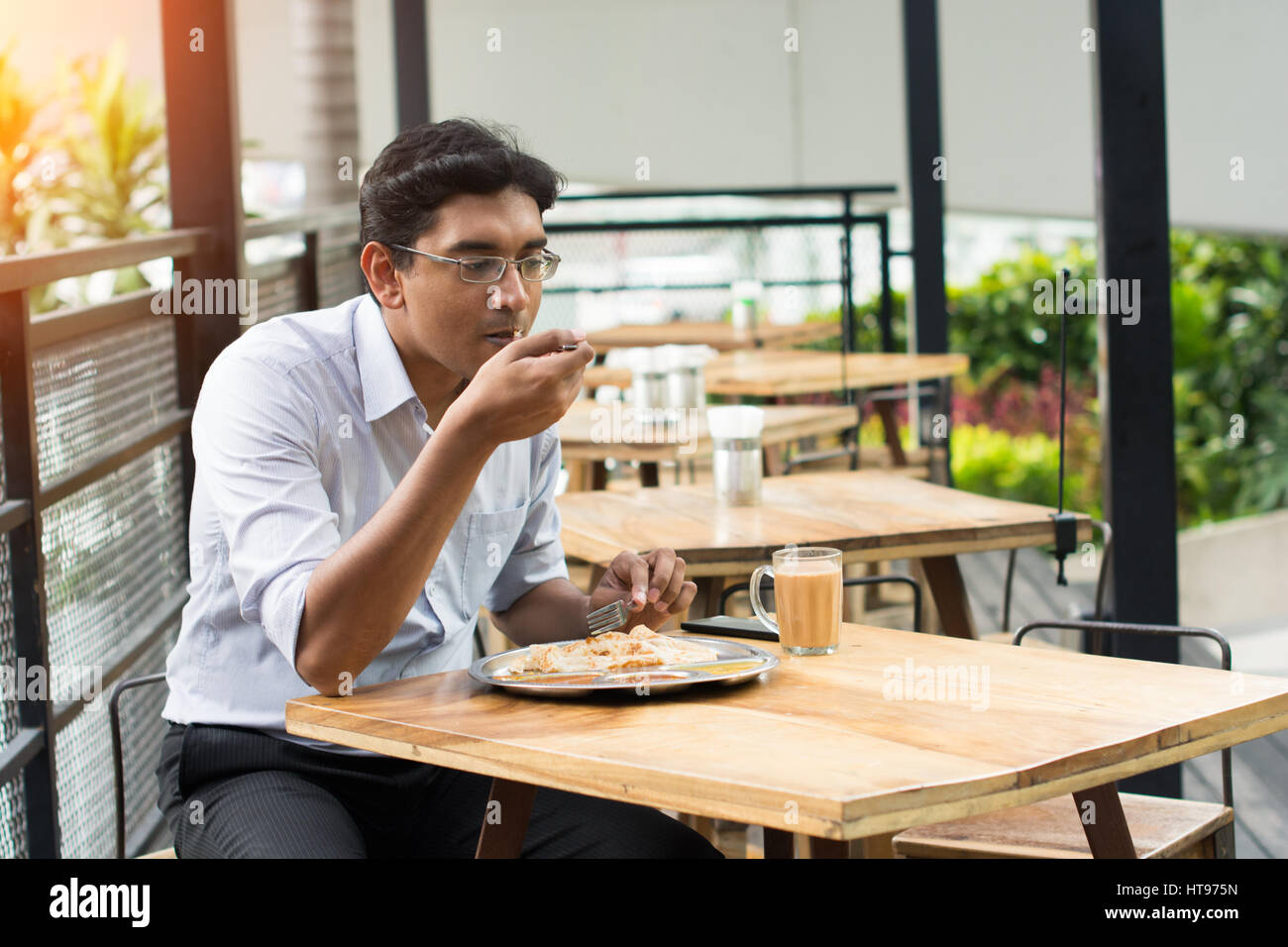 asian business man having roti canai outdoor Stock Photo - Alamy