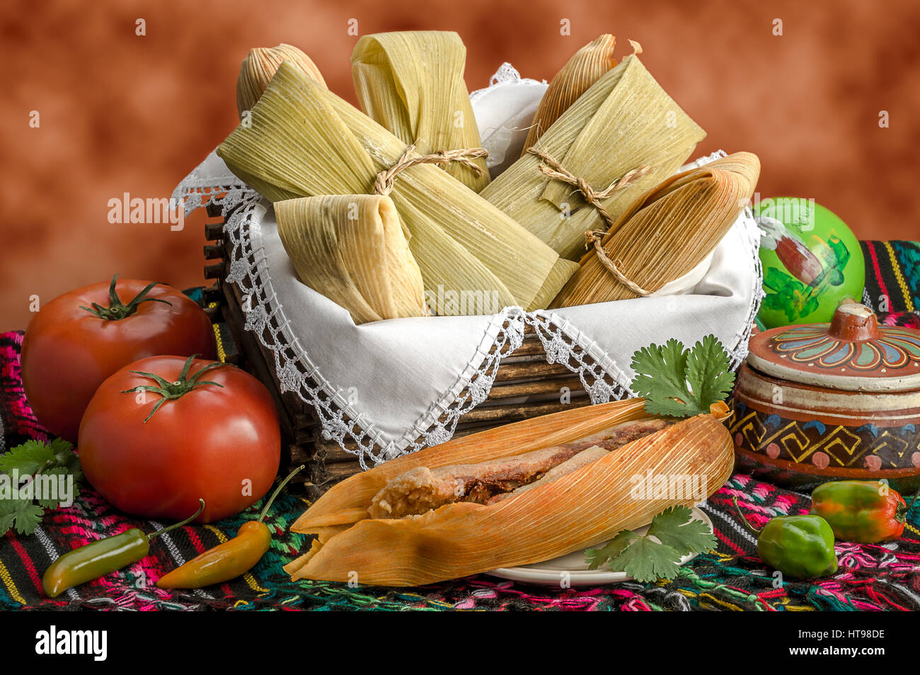 Tamales, Mexican dish made with corn dough, chicken and chili, wrapped ...