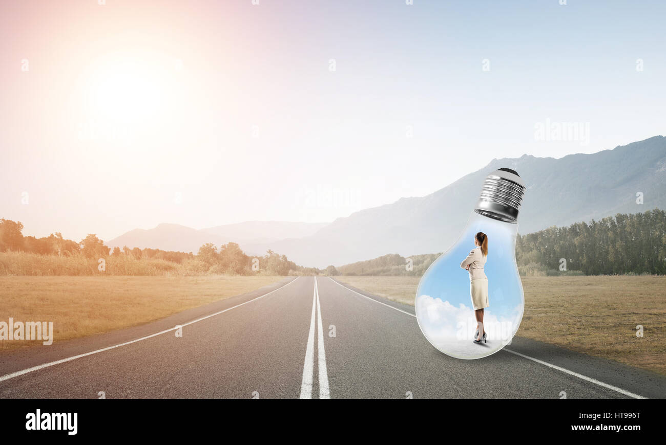 Businesswoman inside light bulb Stock Photo - Alamy