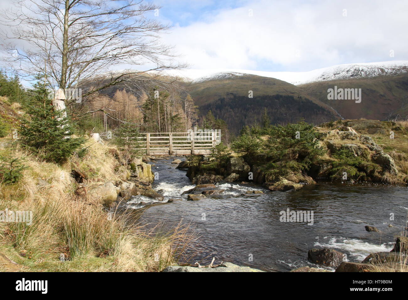 The bridge over the outlet river from Harrop Tarn in the English Lake ...
