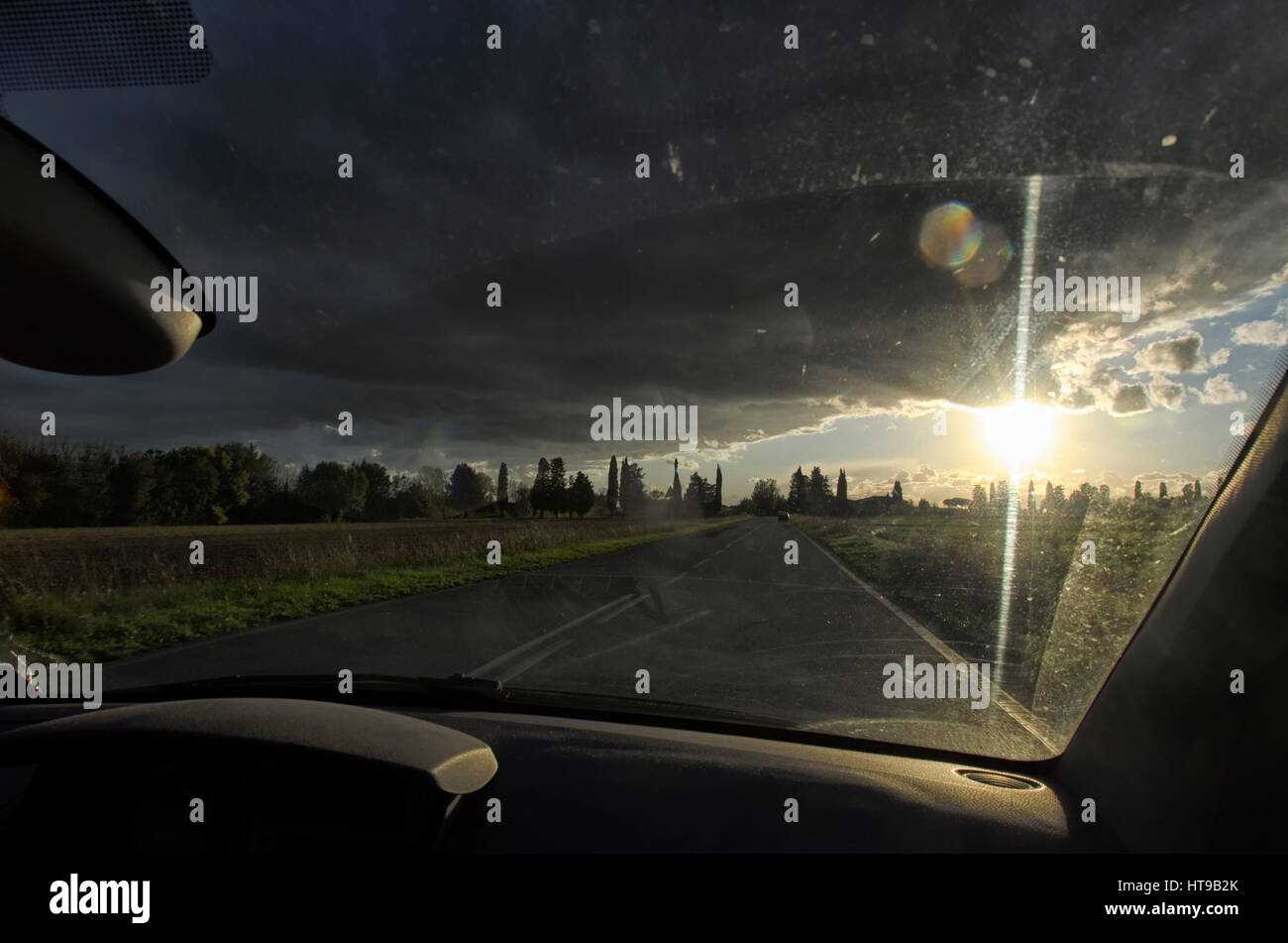 Cloudscape and sunset from inside a car Stock Photo - Alamy