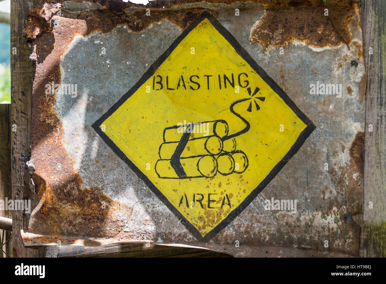 Blasting area warning sign, old and rusty Stock Photo - Alamy