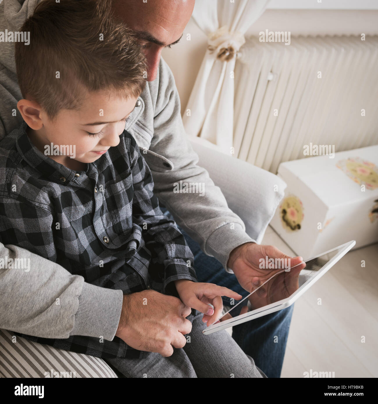Father and son playing with digital tablet Stock Photo - Alamy
