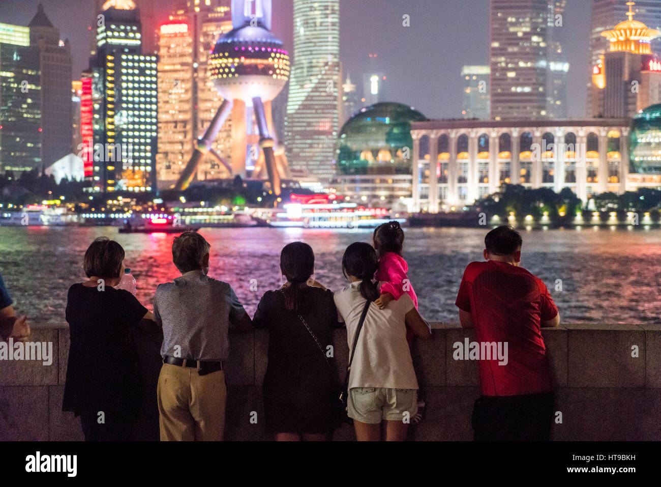 A family looks out towards the skyscrapers of Shanghai Stock Photo - Alamy
