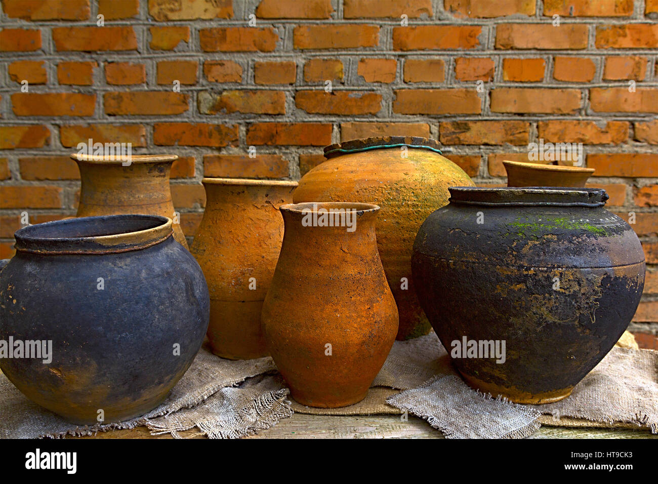 pottery clay pots, standing on a wooden table on a background of a ...