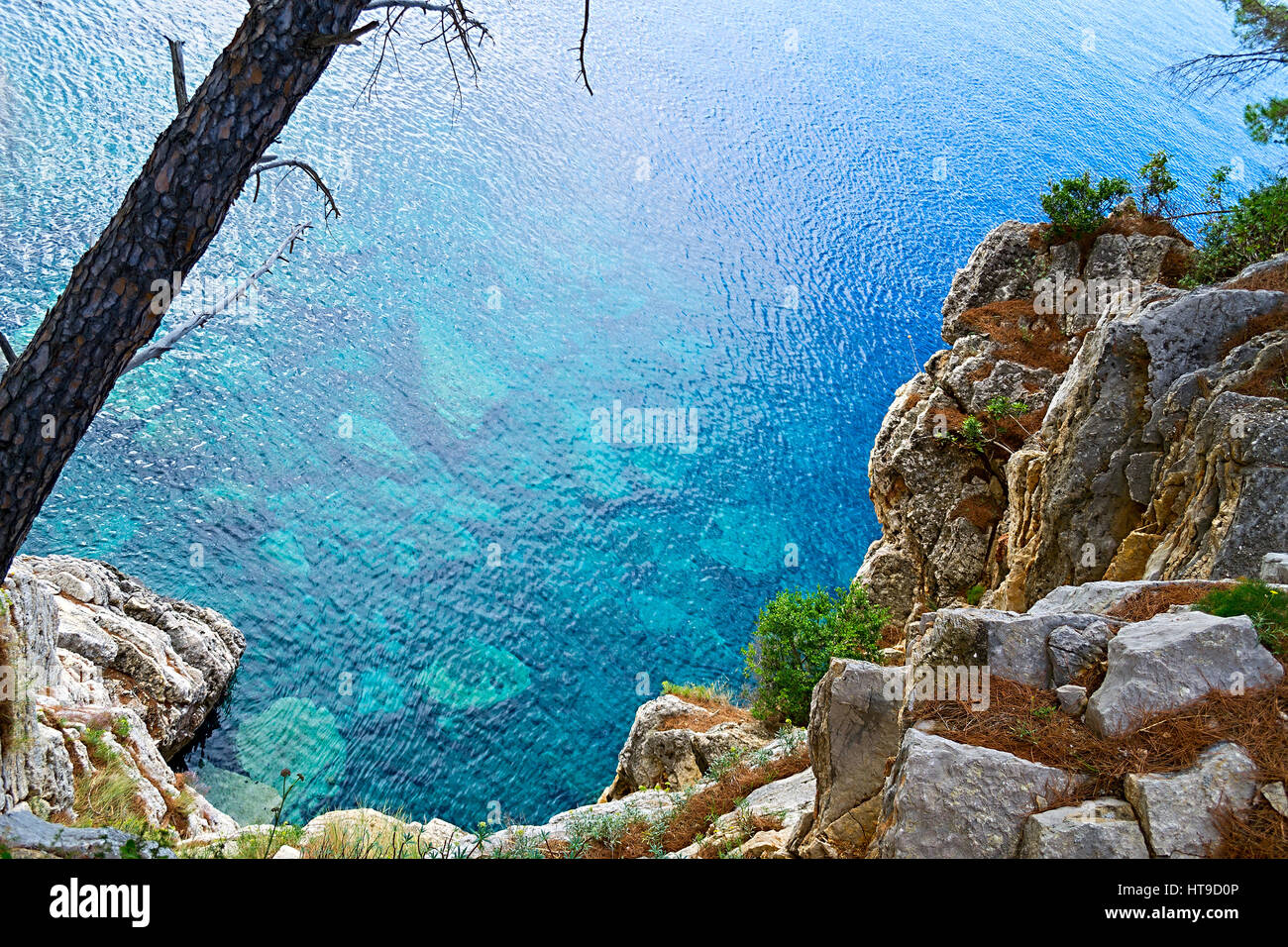 The rock is surrounded by water and sea waves beating against the rock ...