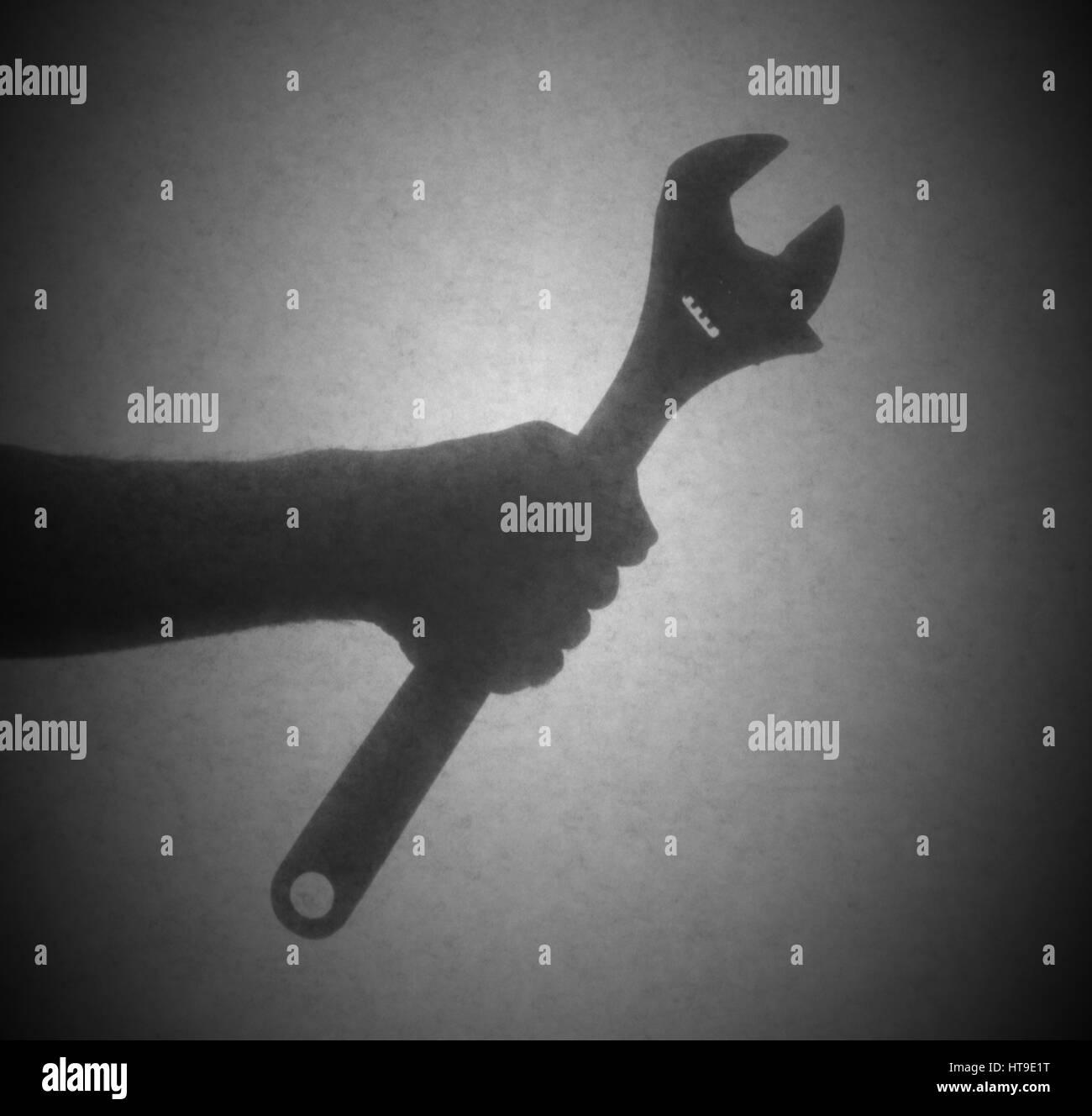 Silhouette behind a transparent paper - English wrench Stock Photo - Alamy