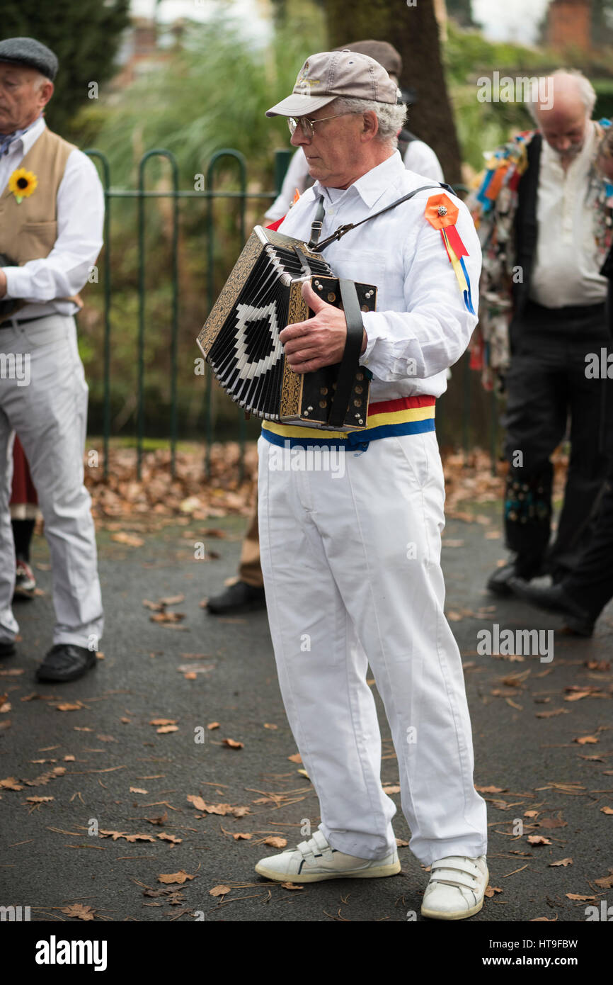 Musician playing the accordion while Morris dancers dance at the ...