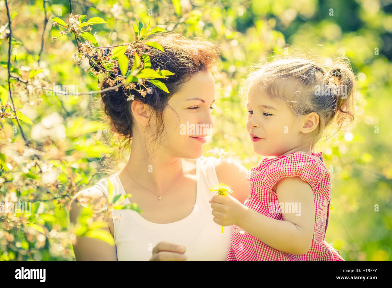 Mother and daughter in spring sunny park Stock Photo - Alamy
