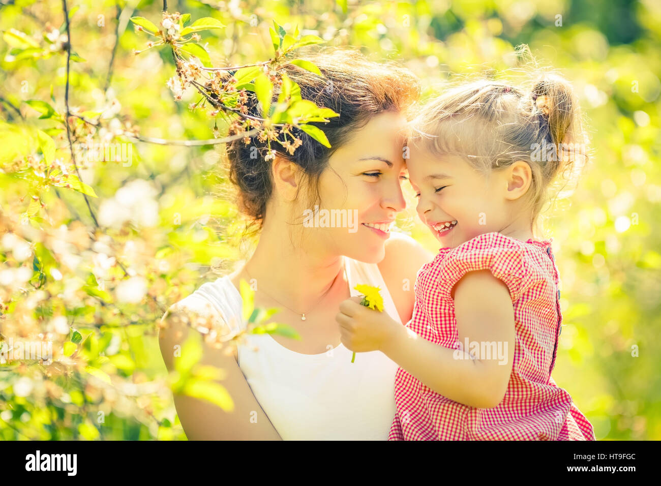 Mother and daughter in spring sunny park Stock Photo - Alamy