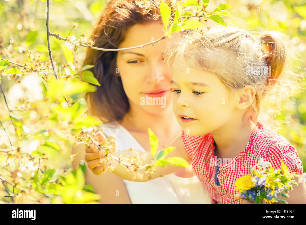 Mother and daughter in spring sunny park Stock Photo - Alamy