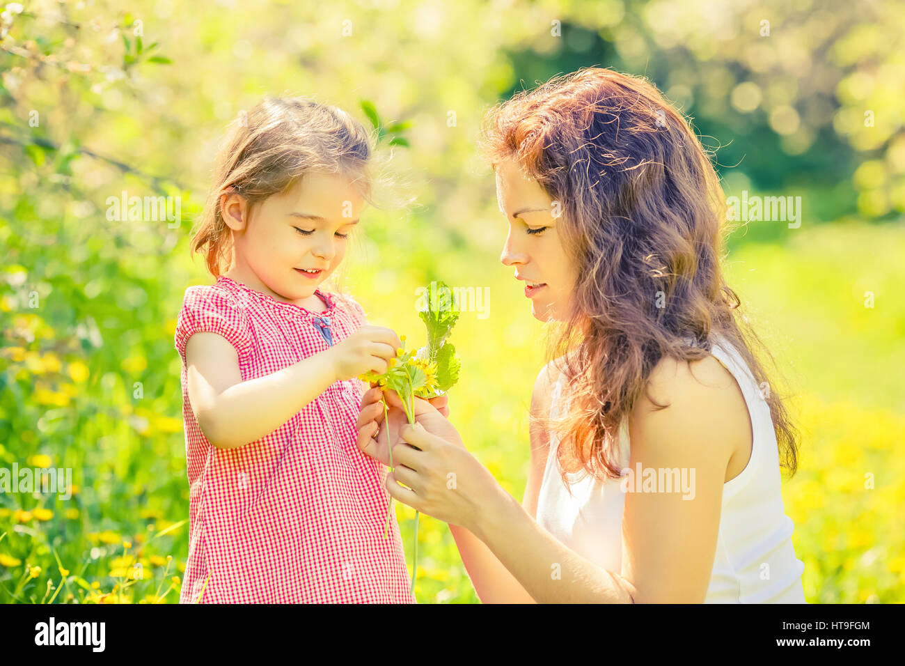 Mother and daughter in spring sunny park Stock Photo - Alamy