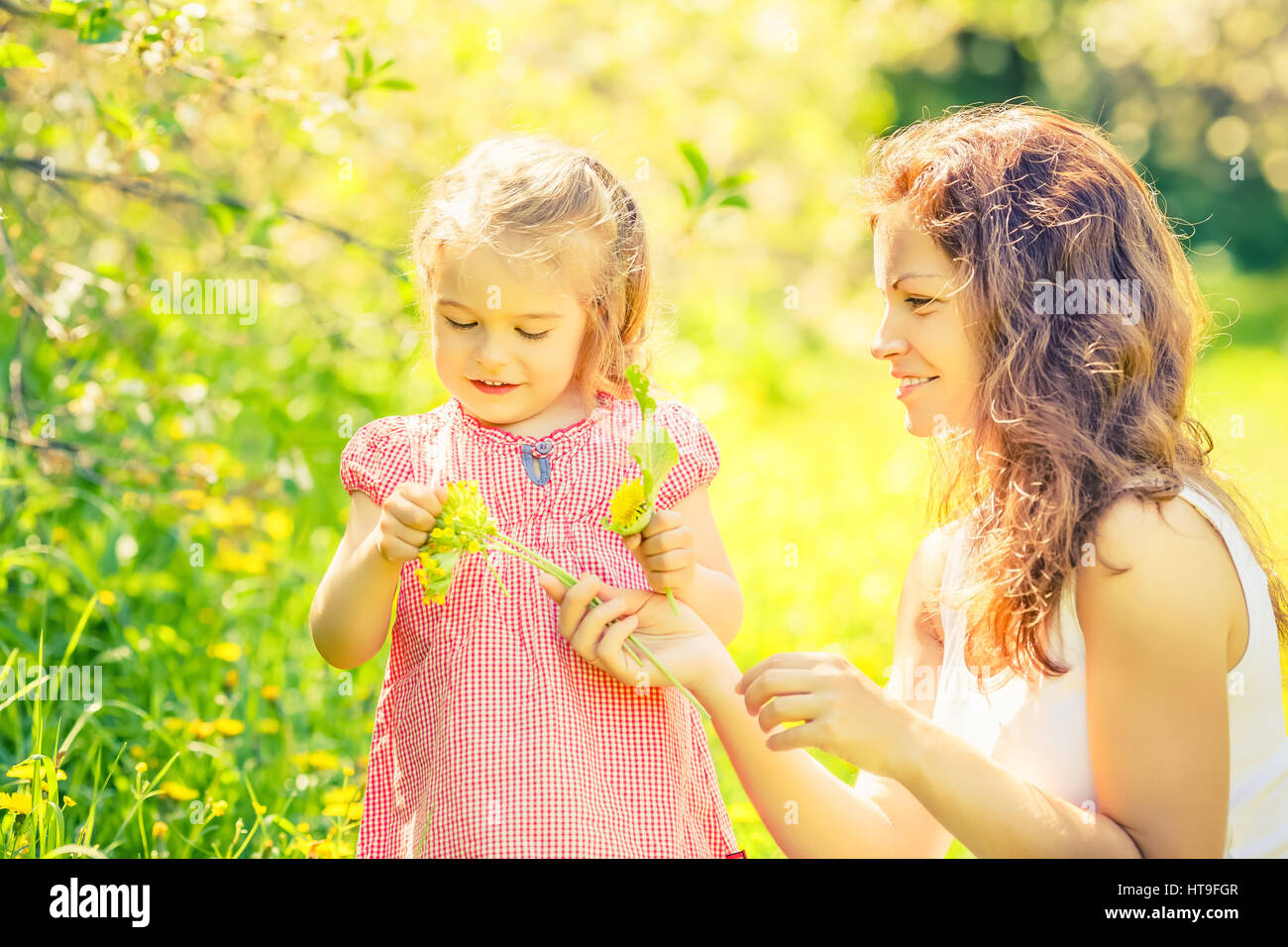 Mother and daughter in spring sunny park Stock Photo - Alamy