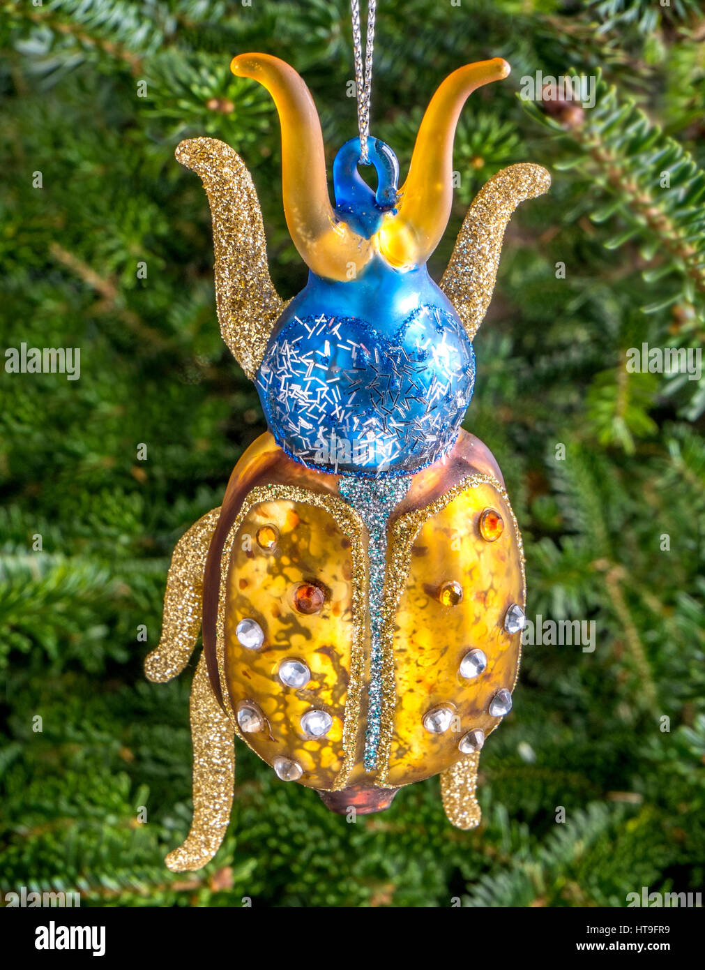 Christmas bauble hanging from a tree in the shape of a Jeweled Insect ...