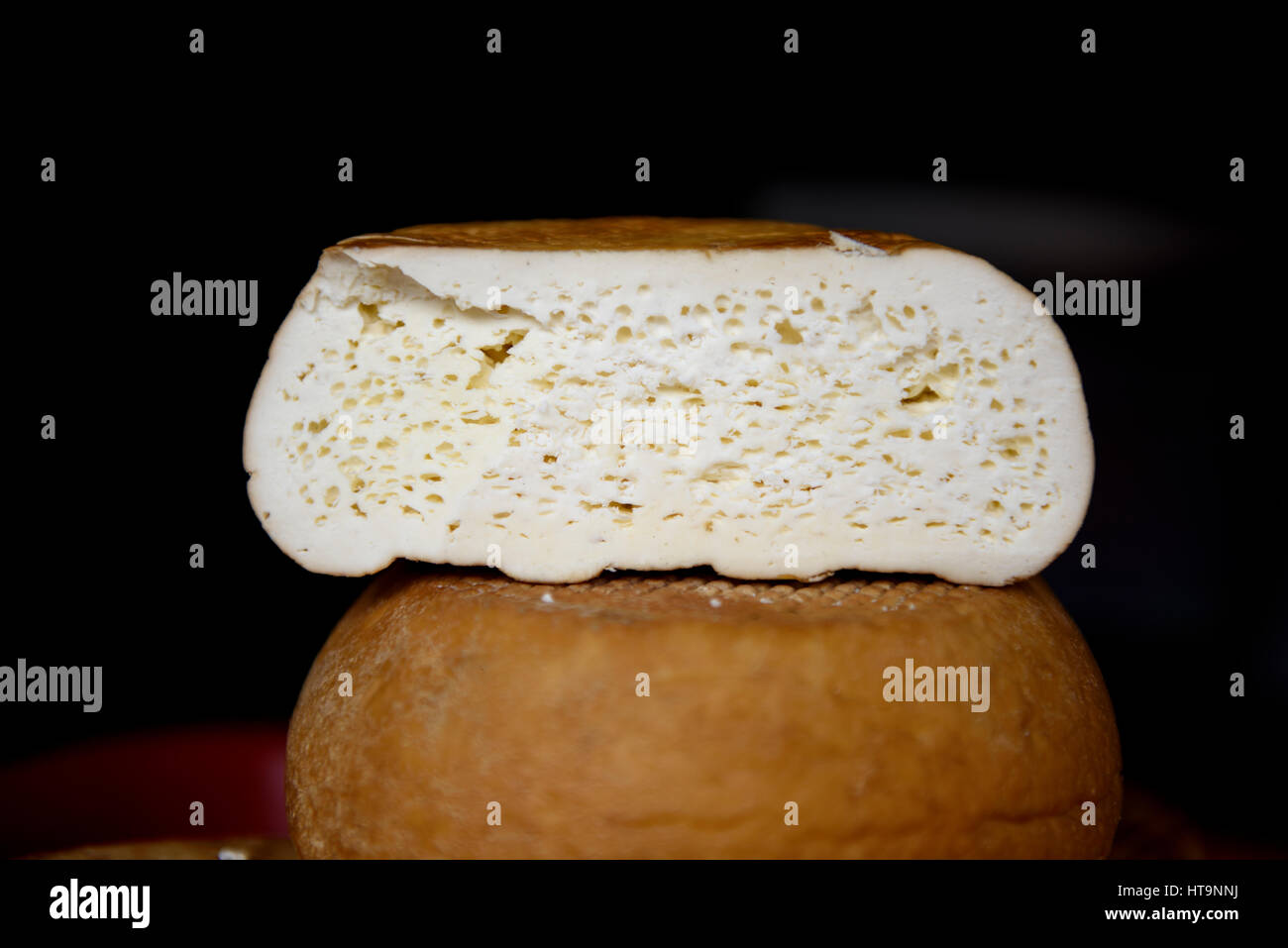 Close up of the cut cheese wheel sold at the road market stalls located ...