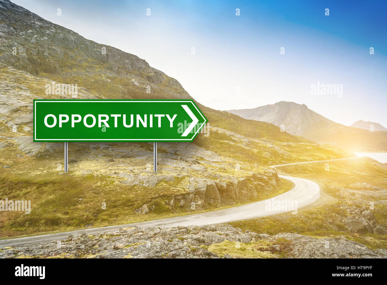 opportunity words on green road sign with the curve road Stock Photo ...