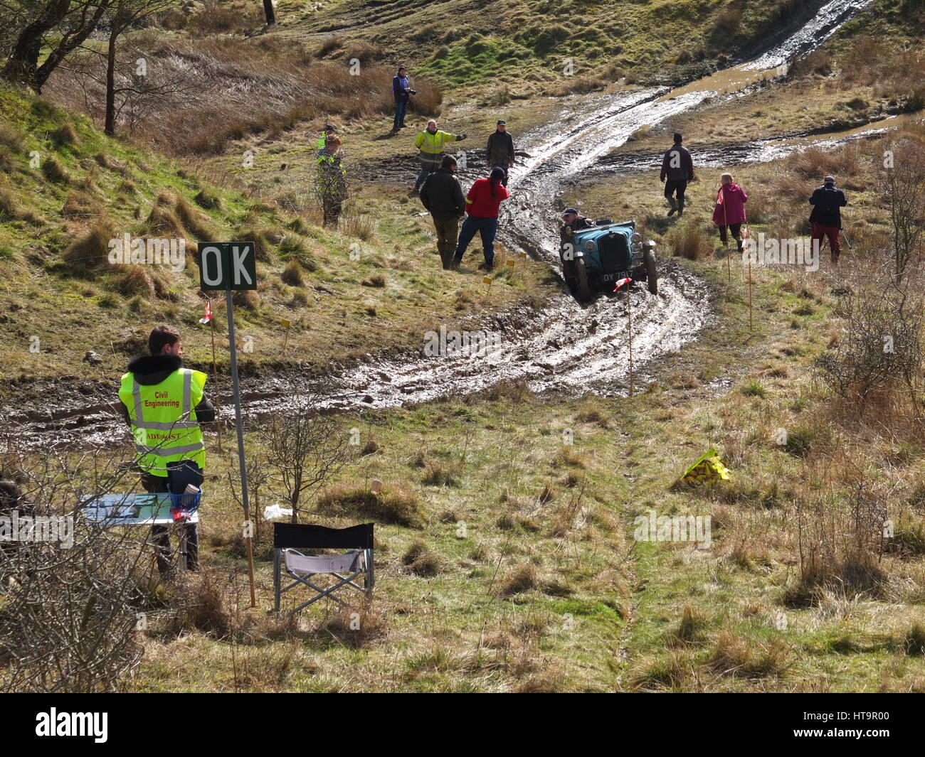 A vintage Austin Ulster struggles to mount a muddy bank in Clough Wood ...