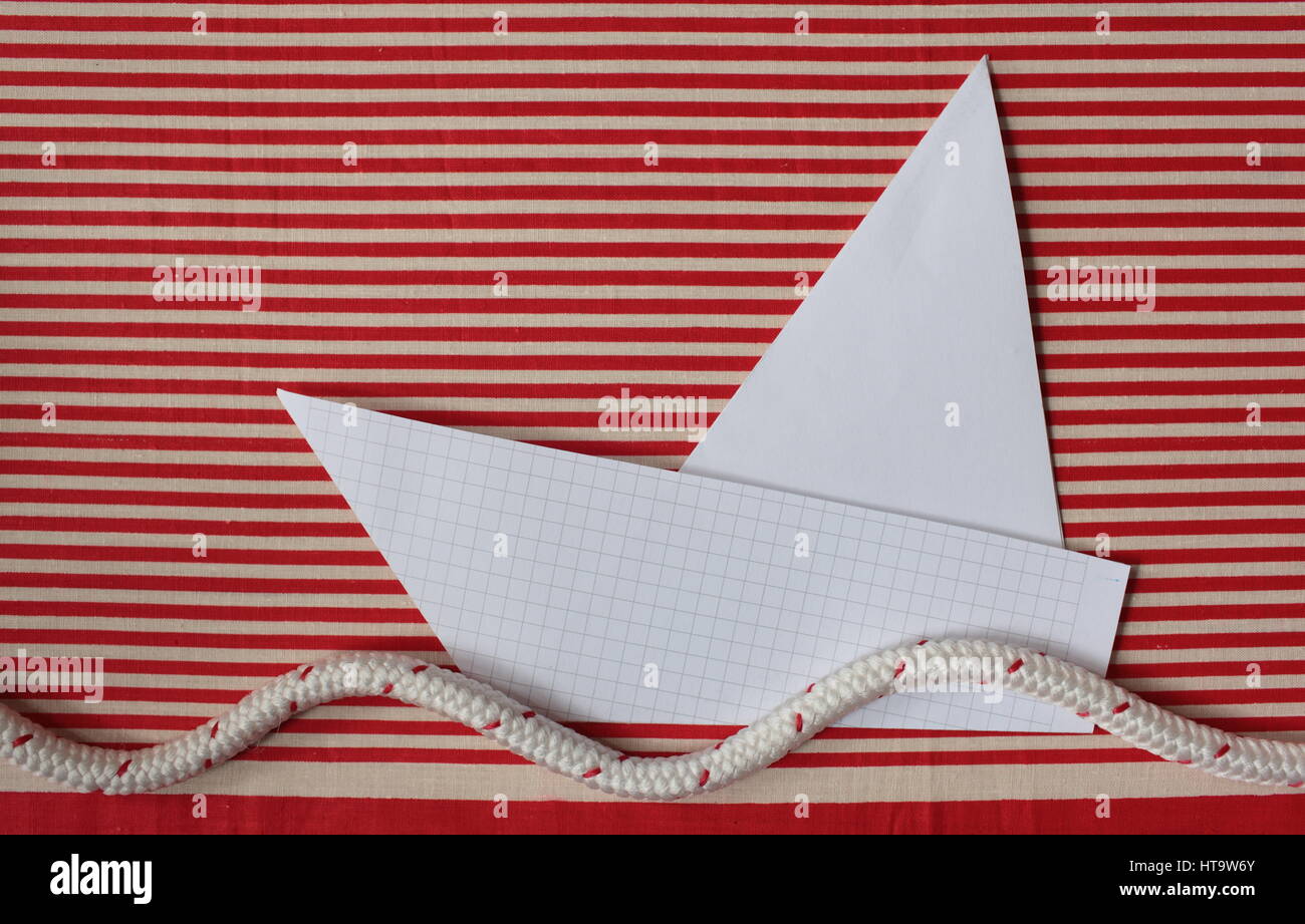 origami white paper yacht. red striped sea. flat lay Stock Photo - Alamy