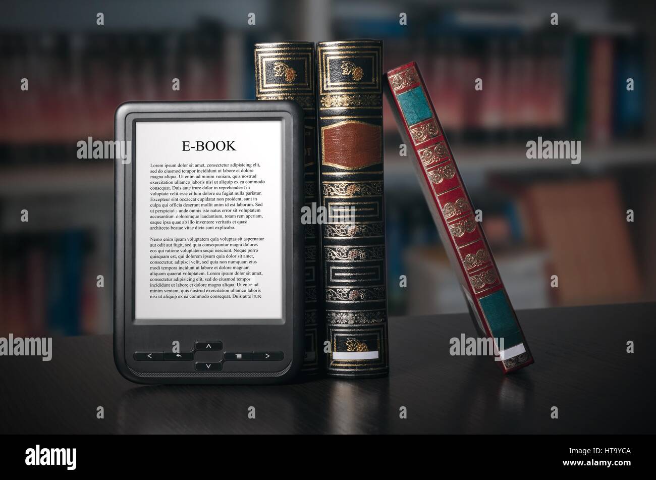 E-book reader device on desk in library. Alternative for traditional ...