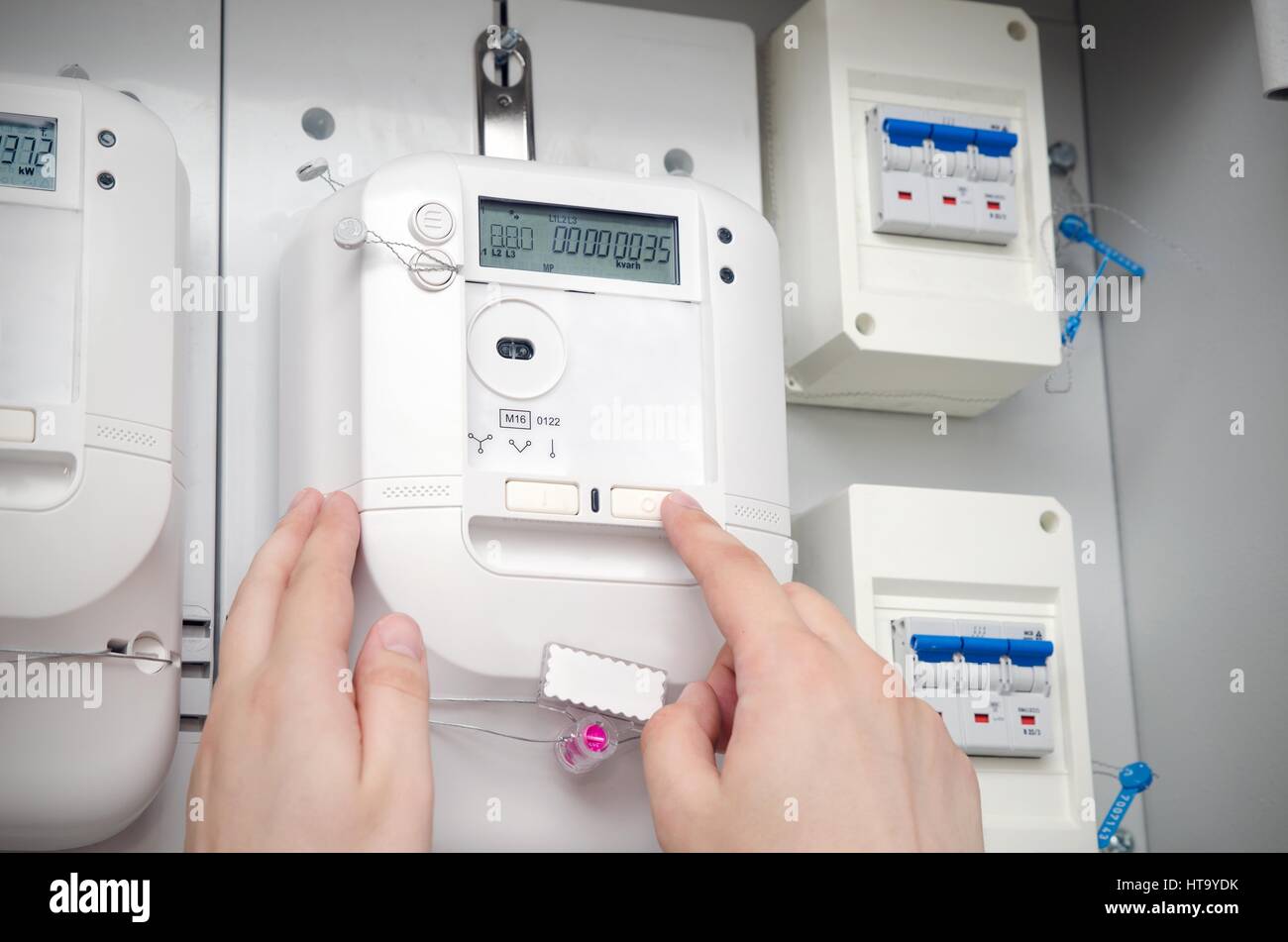 Electric energy meter. Electrical technician servicing unit Stock Photo ...