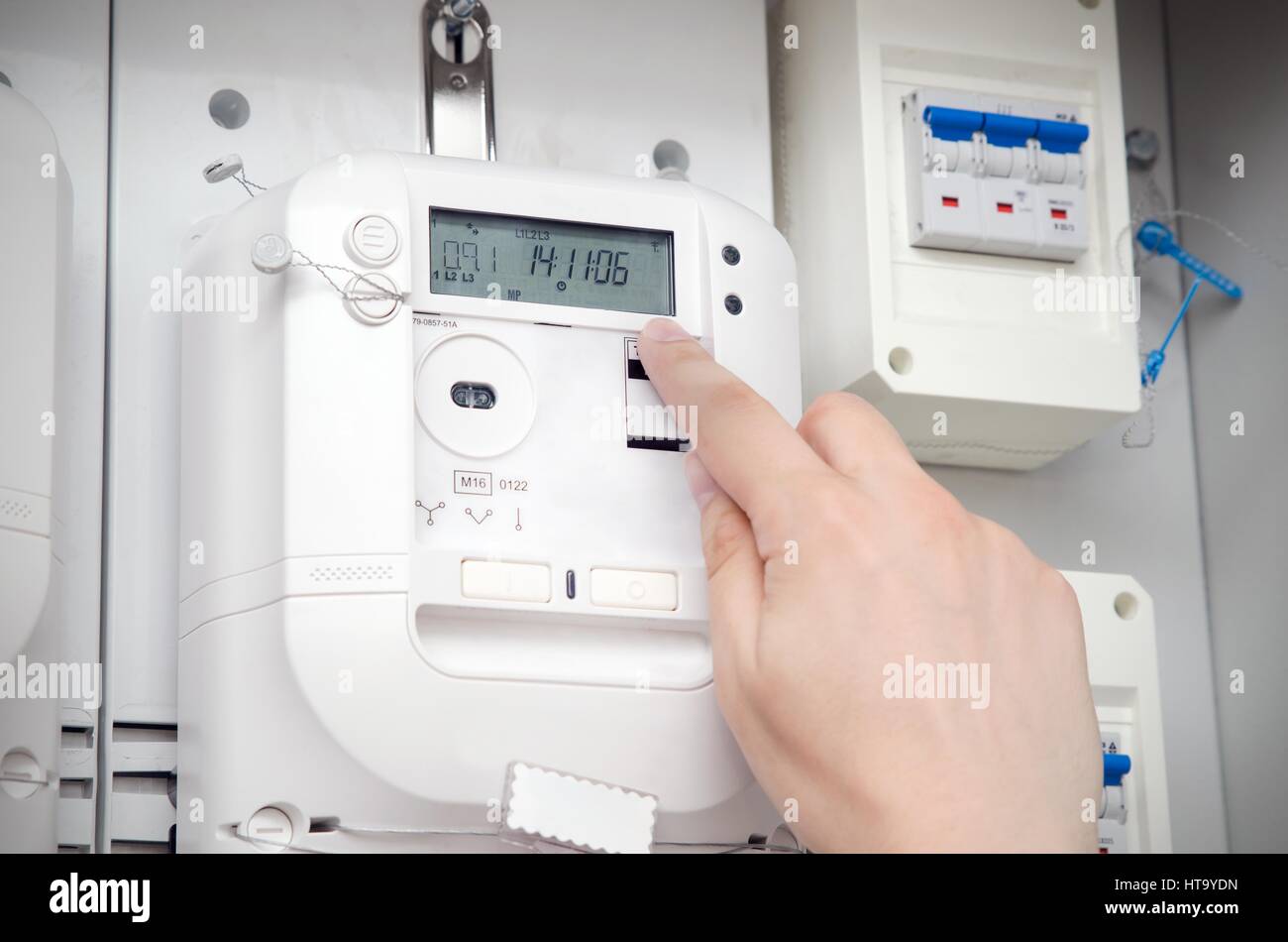 Electric energy meter. Electrical technician servicing unit Stock Photo ...