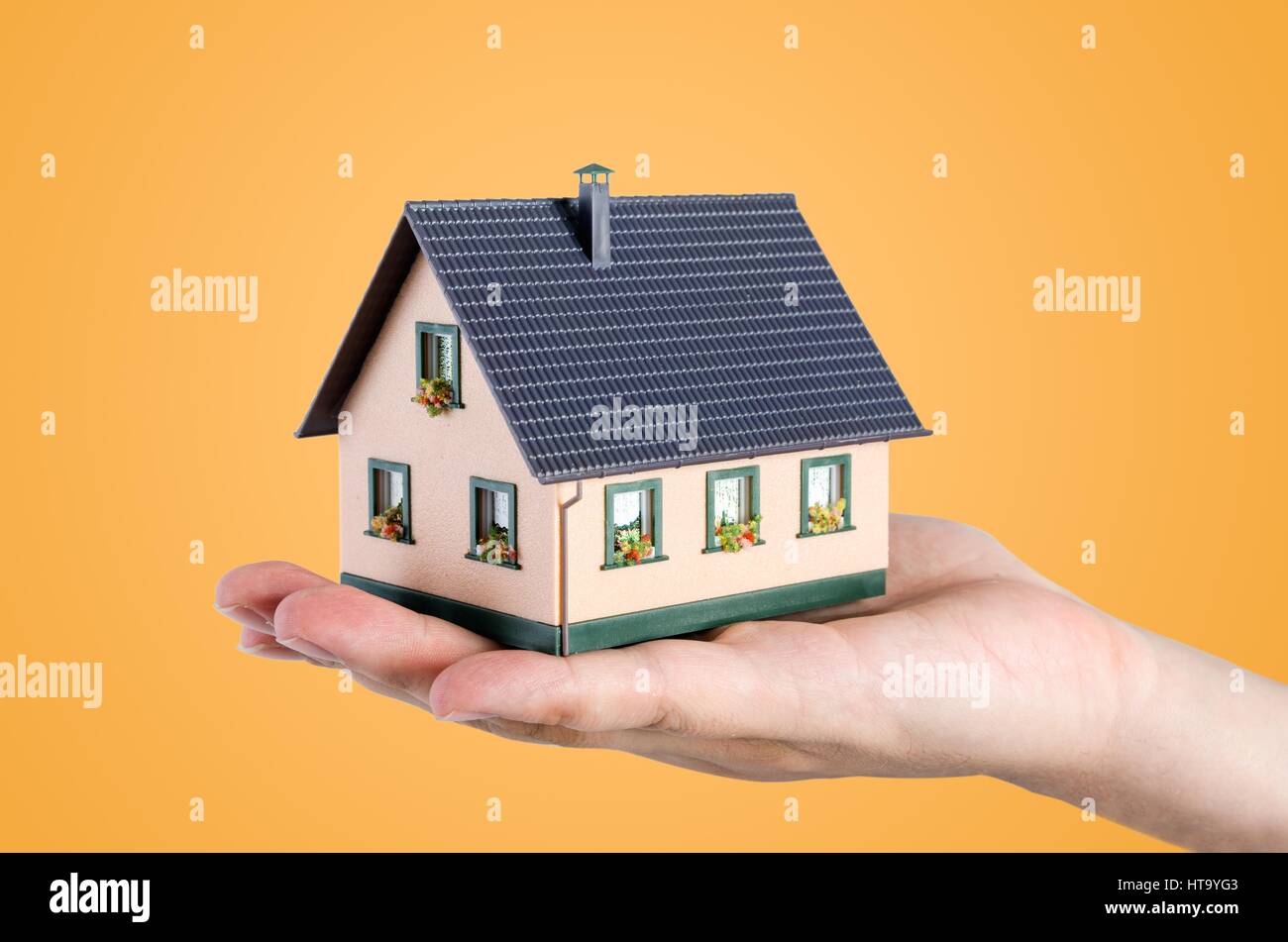 Hand holding house miniature. Home budget and finance concept Stock ...