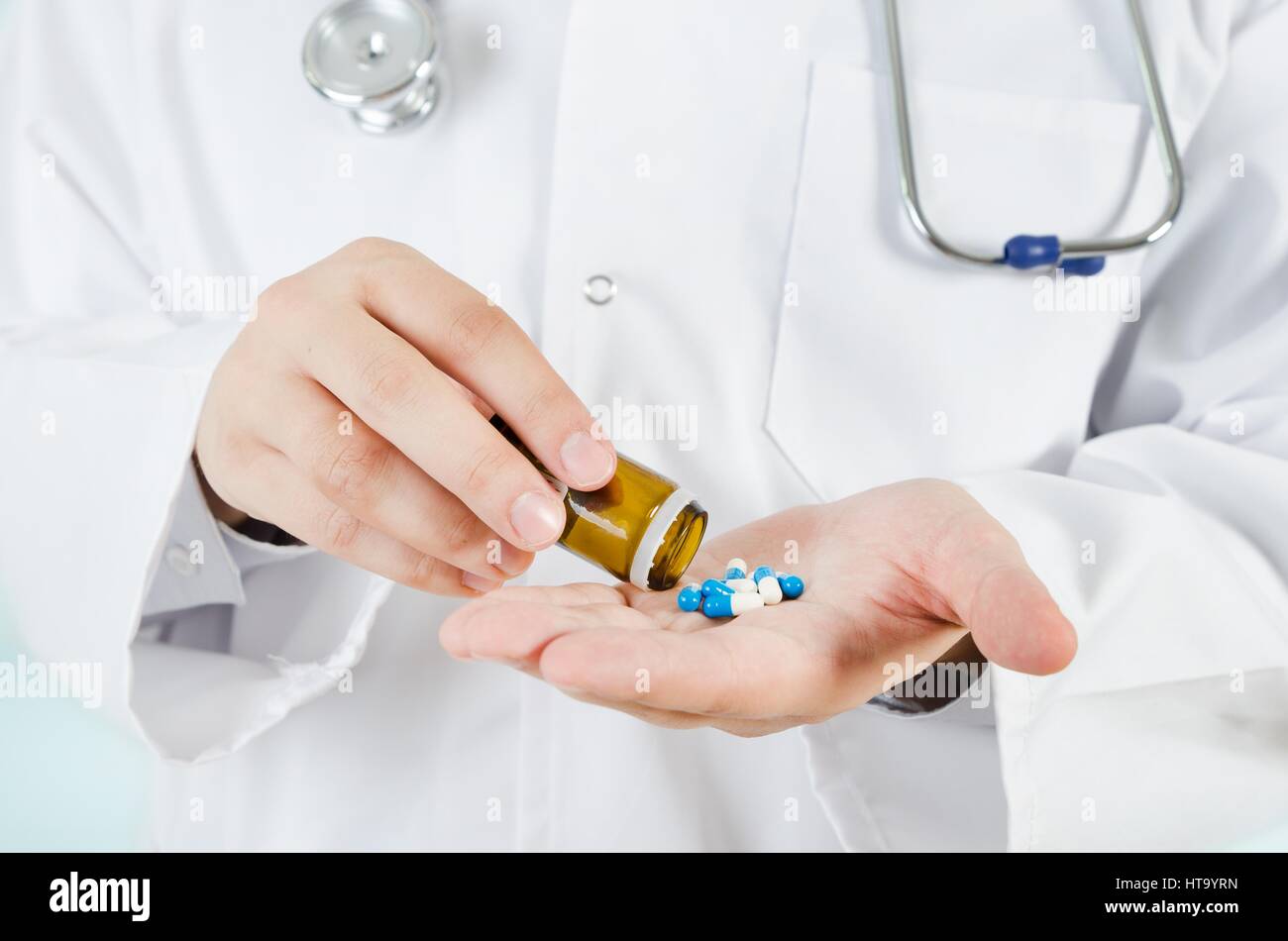 Doctor pouring pills on his hand. Medical concept in hospital on ...