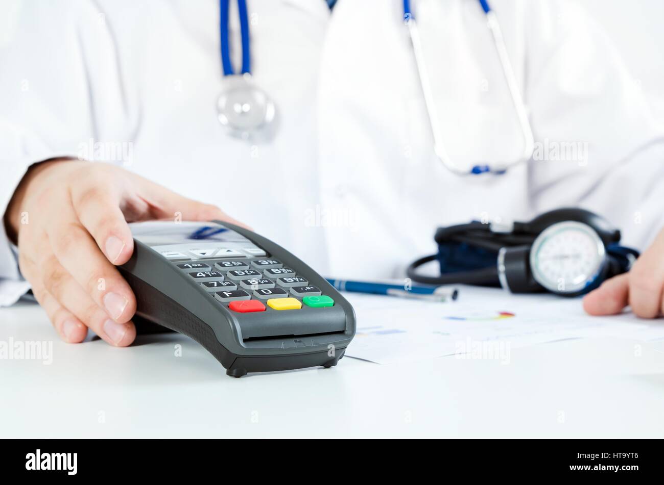 POS terminal in doctor's office. Pay for private health care concept ...