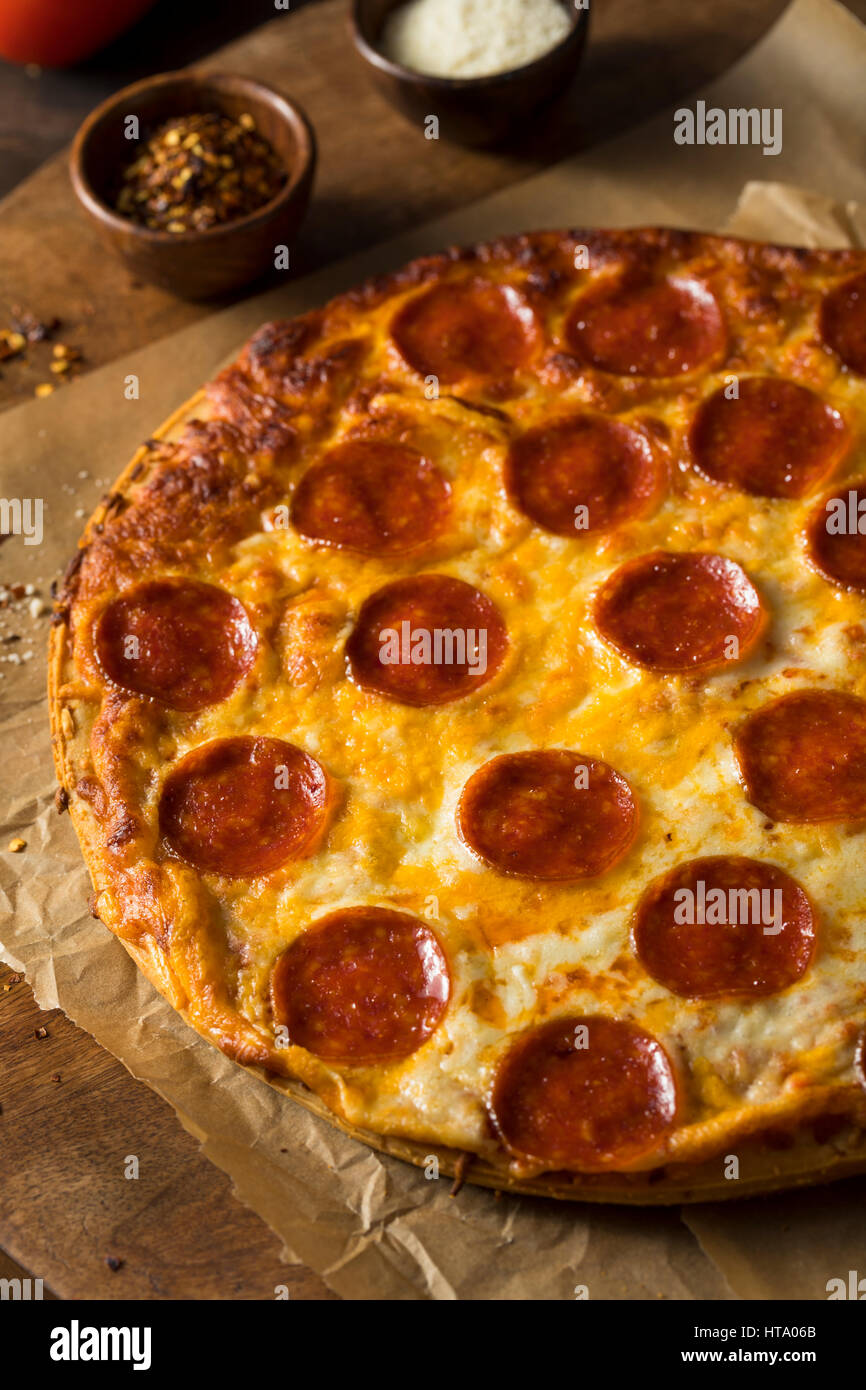 Cheap Greasy Frozen Pepperoni Pizza Ready to Eat Stock Photo - Alamy