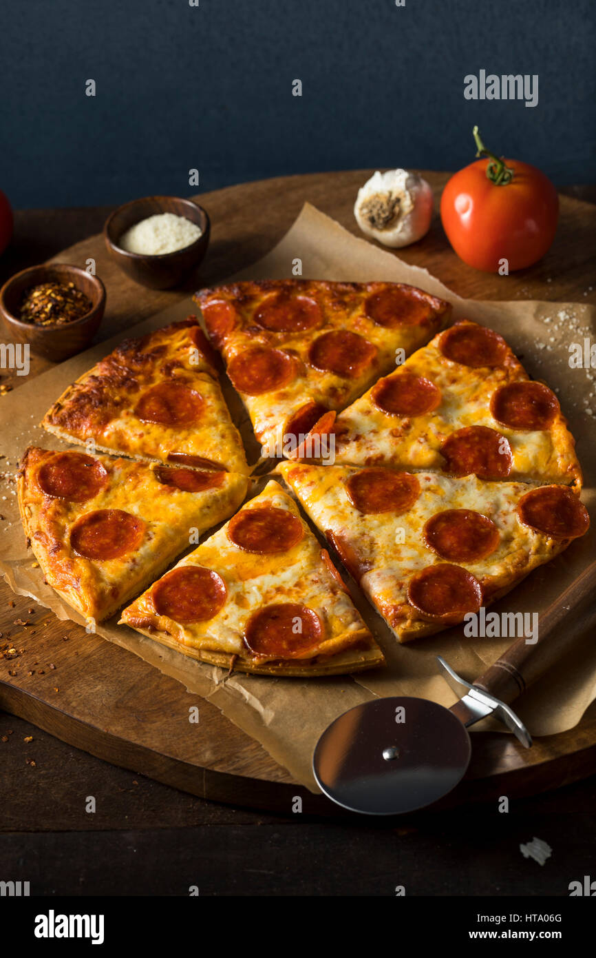 Cheap Greasy Frozen Pepperoni Pizza Ready to Eat Stock Photo - Alamy