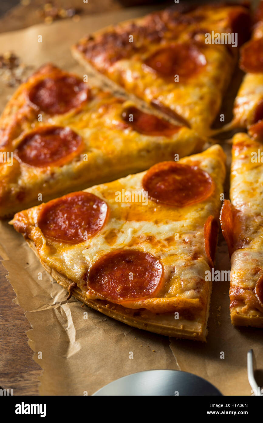 Cheap Greasy Frozen Pepperoni Pizza Ready to Eat Stock Photo - Alamy