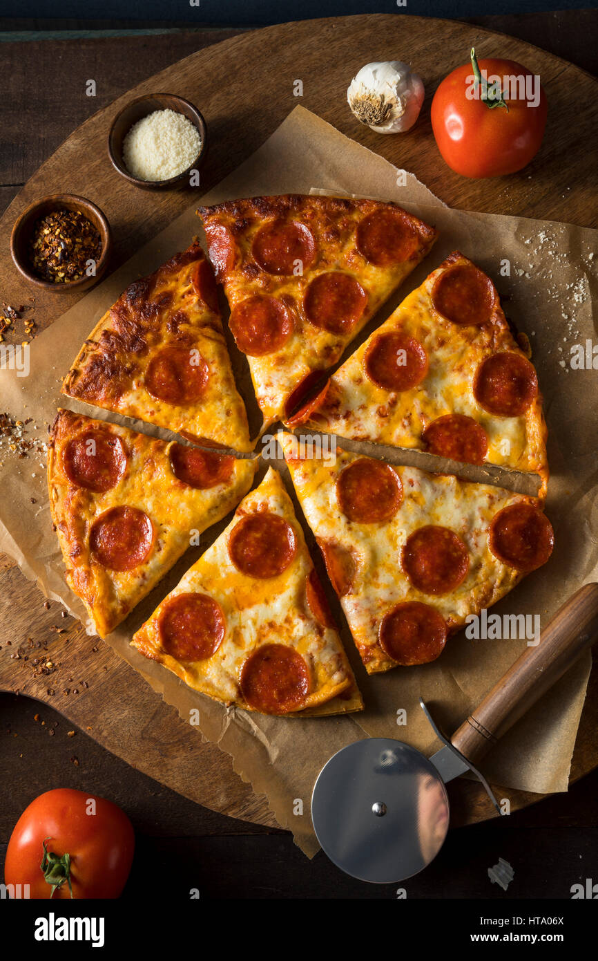 Cheap Greasy Frozen Pepperoni Pizza Ready to Eat Stock Photo - Alamy