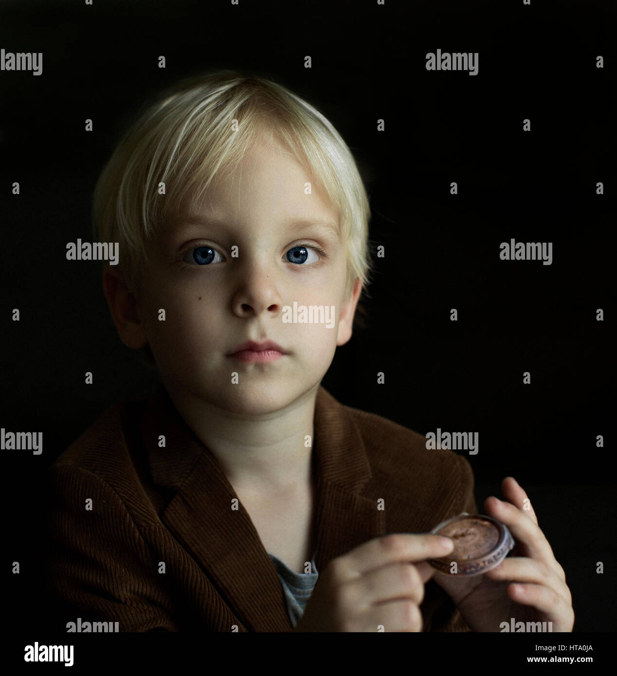 Portrait of a little boy holding a retro style watch in his hands Stock ...
