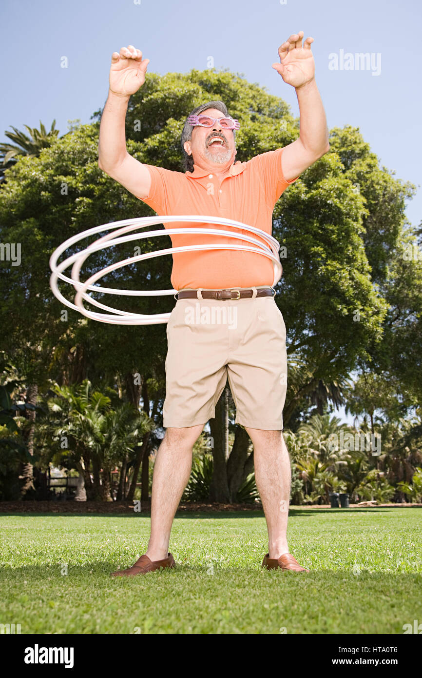 Young man spinning hula hoop hi-res stock photography and images - Alamy
