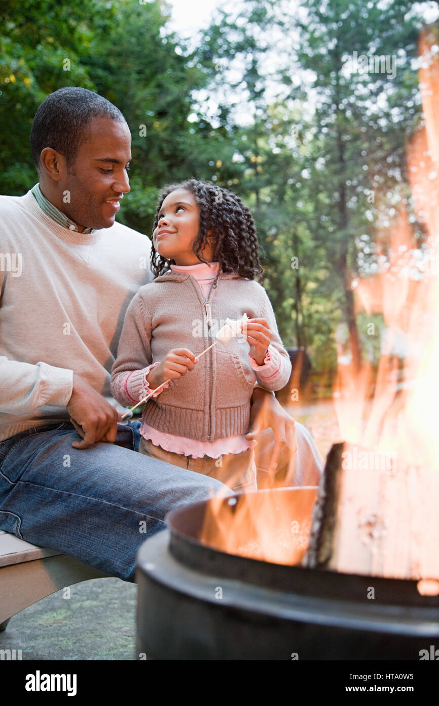 Father and daughter by fire Stock Photo - Alamy