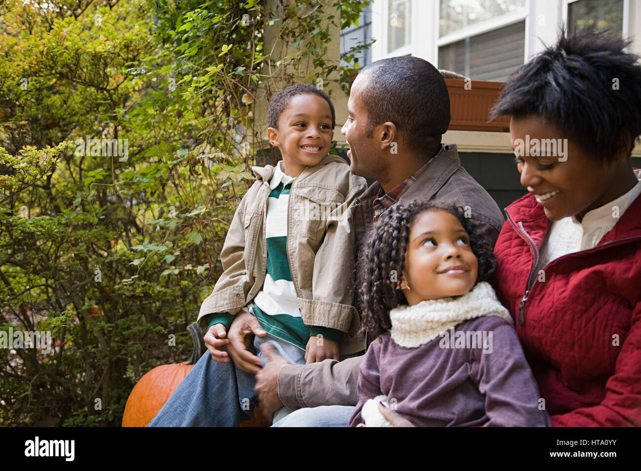 Family in front of house Stock Photo - Alamy