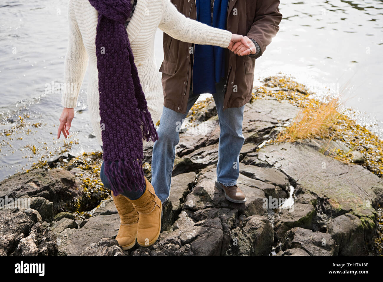Mature couple climbing rocks Stock Photo - Alamy