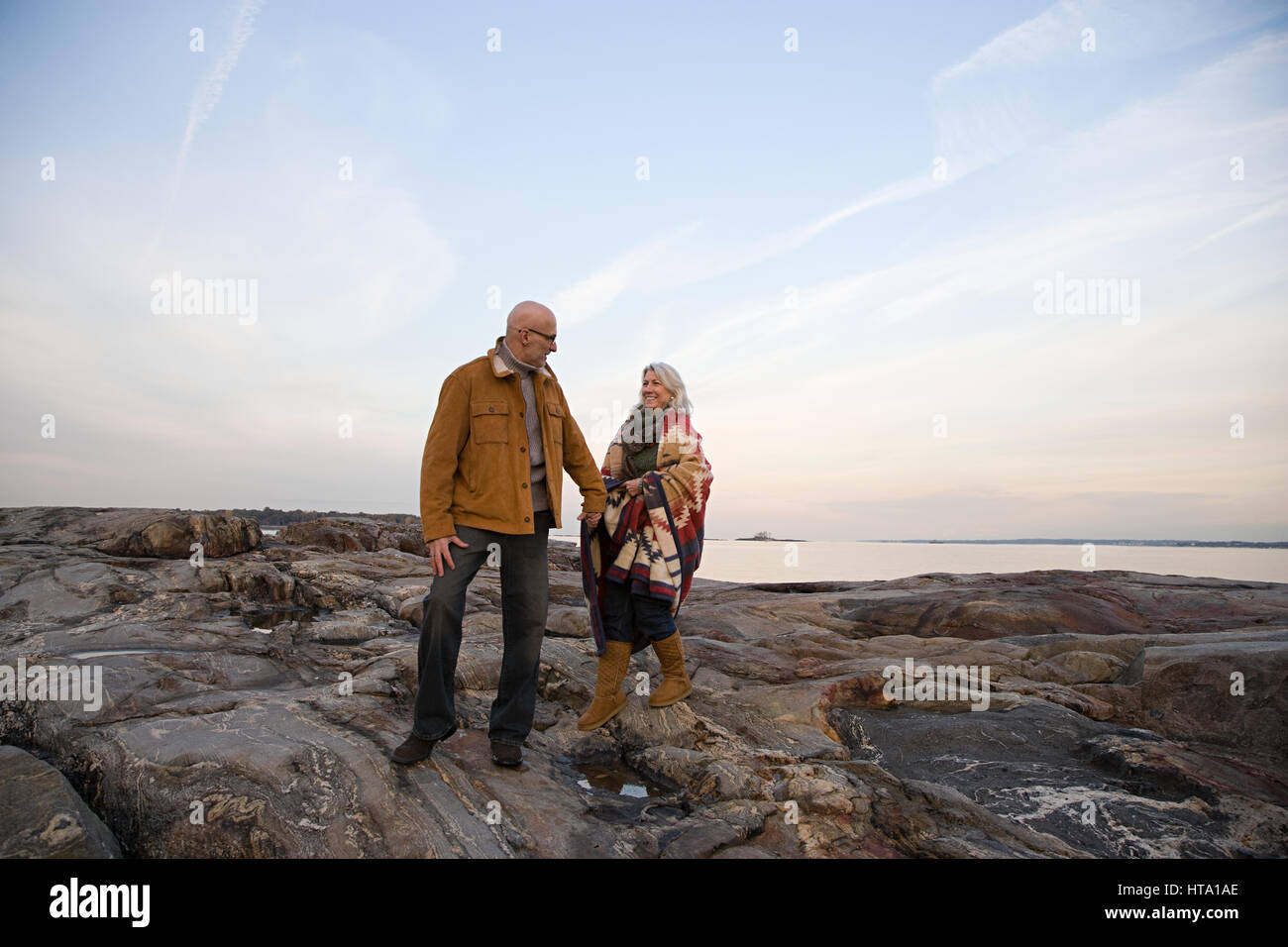 Two people walking over rocks hi-res stock photography and images - Alamy