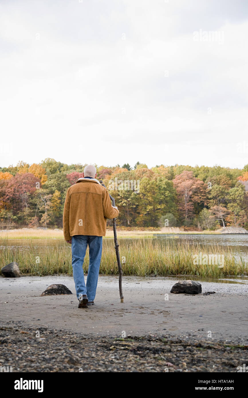 Man walking with a stick Stock Photo - Alamy