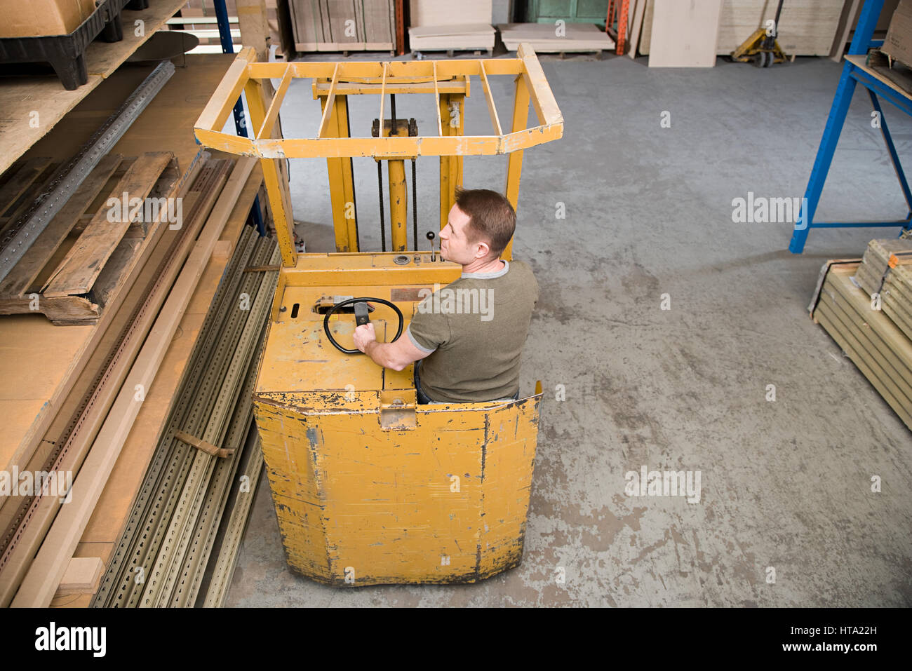 Man in forklift truck Stock Photo - Alamy
